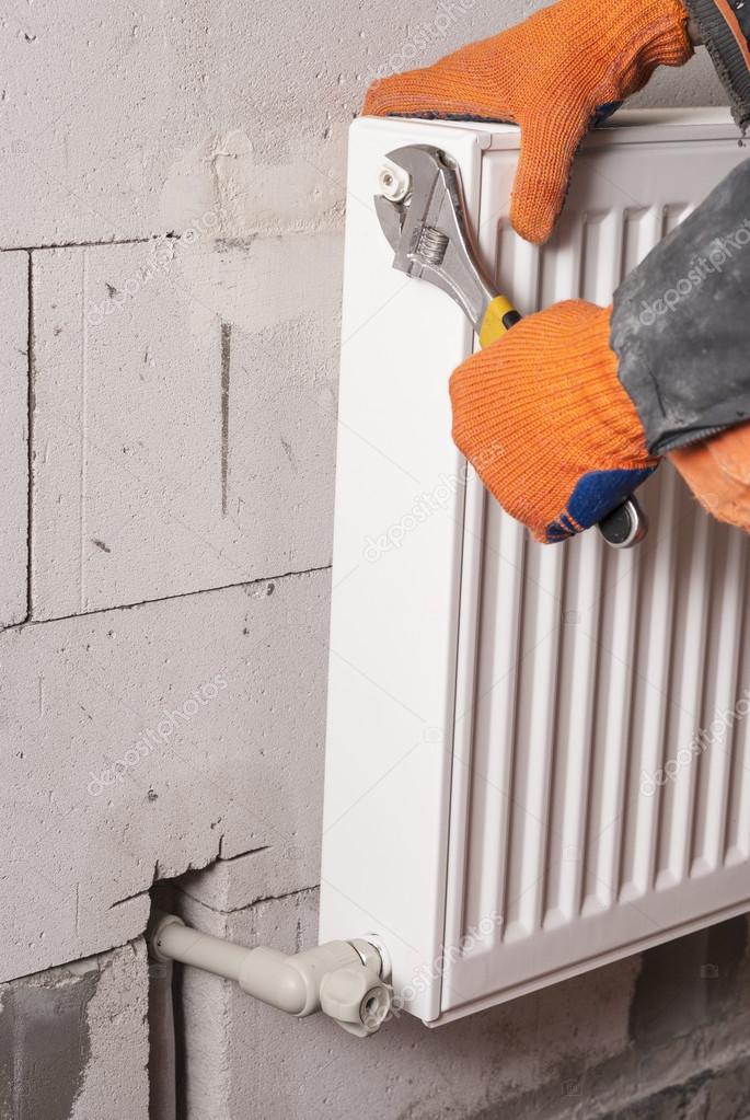 Heating radiator installation Stock Photo by ©mkuchina 109439410