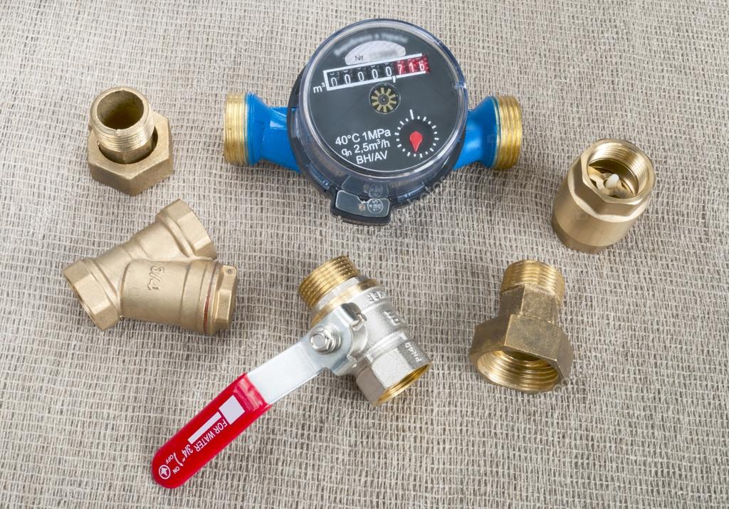 Water meter and various plumbing fittings Stock Photo by ©mkuchina 75967129