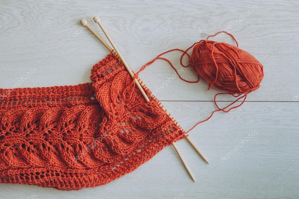 Red wool scarf knitting and and needles — Stock Photo © mimiau #70654151