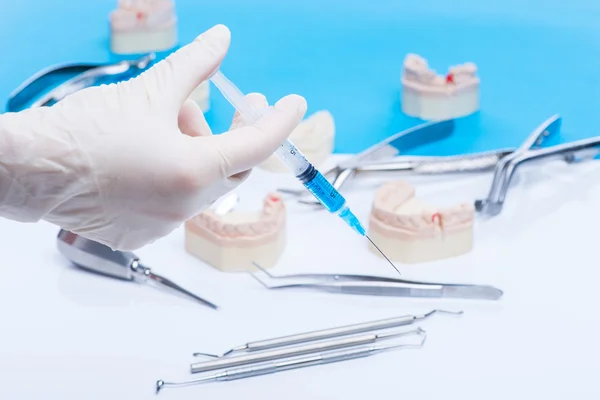 Dentist shows how to do the injection - Stock Image - Everypixel