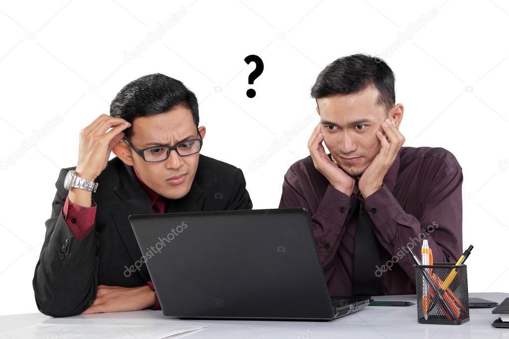 Confused businessmen looking at laptop Stock Photo by ©PepscoStudio ...