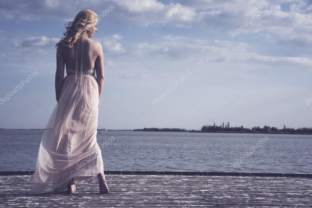 Wind blowing evening gown at lake Stock Photo by ©NewNow 72936313