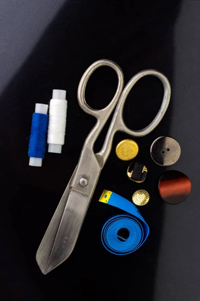 vintage big seamstress scissors, measuring blue tape and buttons on ...