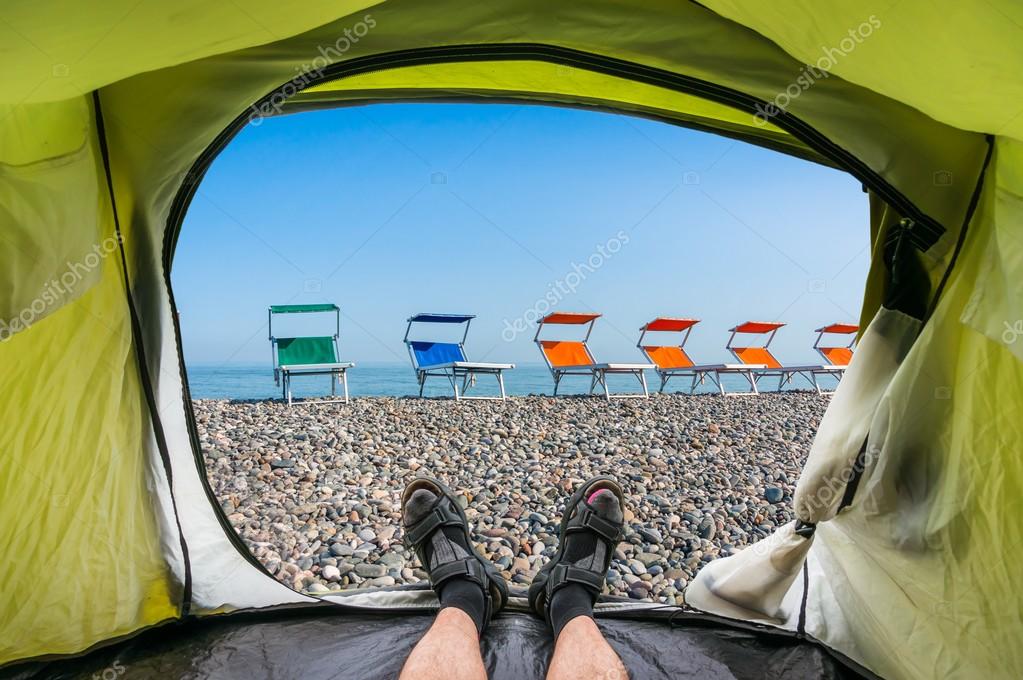 View from inside a tent on the colorful beach chairs — Stock Photo ...