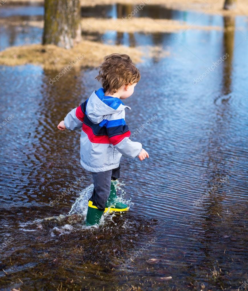 Cute little boy running through puddles Stock Photo by ©juliannafunk ...