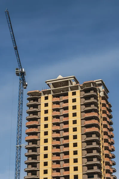 A new high-rise building and three construction cranes — Stock Photo ...