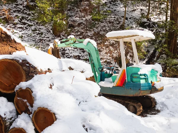 digger or loader work on snow at mountain in winter, excavator stop ...
