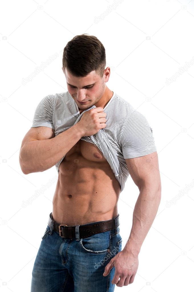 Handsome Fit Young Man Pulling Up T Shirt Revealing Abs On Isolated