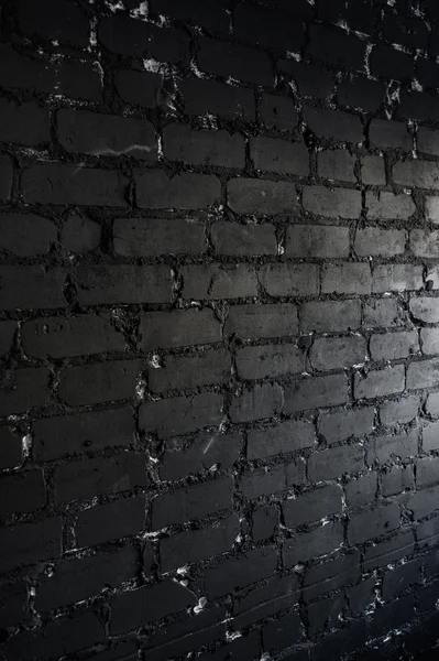 Side view on black brick wall lit by light from the window - Stock ...