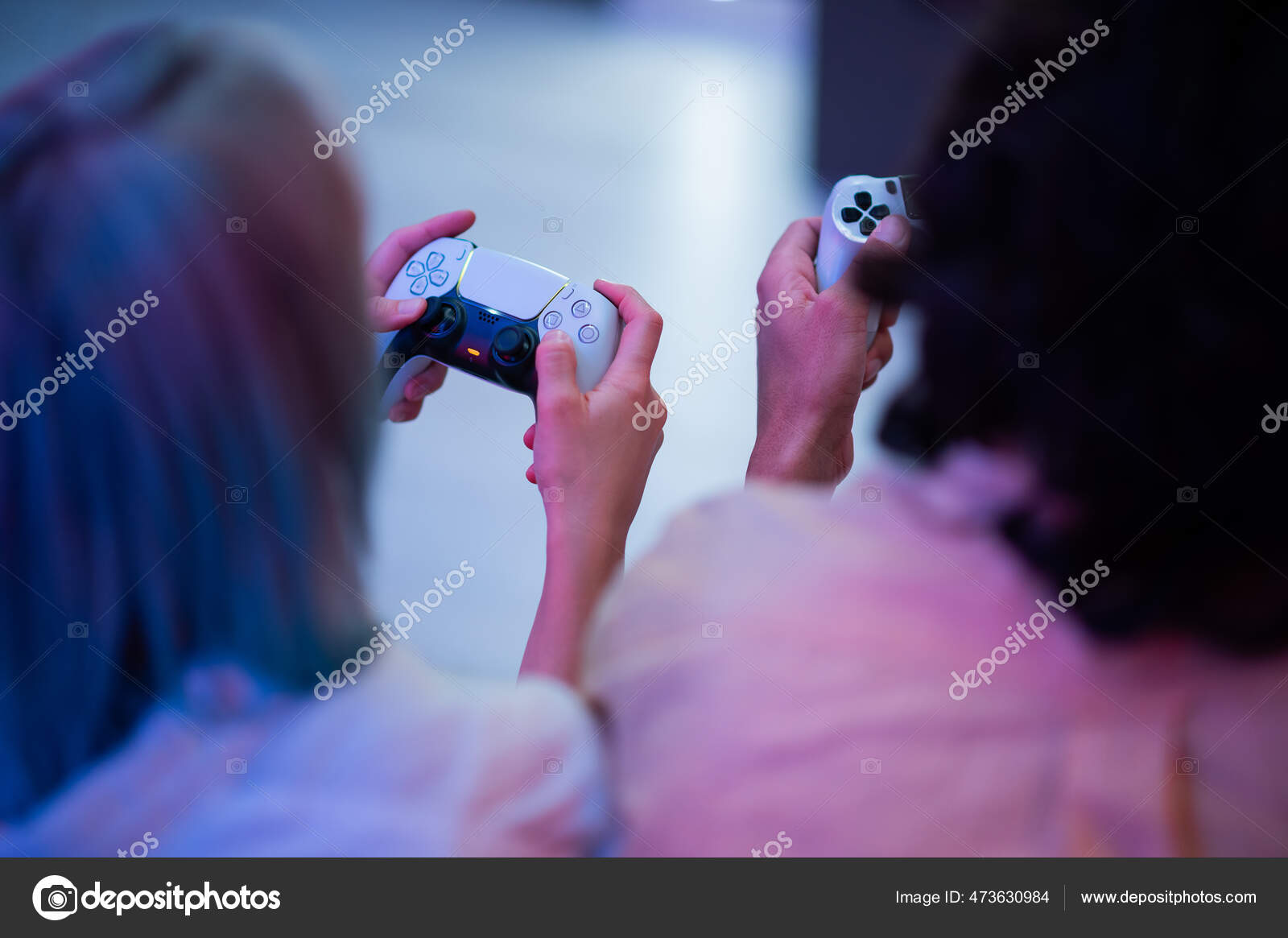 Girl with next gen controller in her hands playing games at home ...