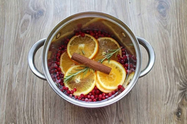 Put a cinnamon stick in a saucepan, press firmly with oranges. - Stock ...