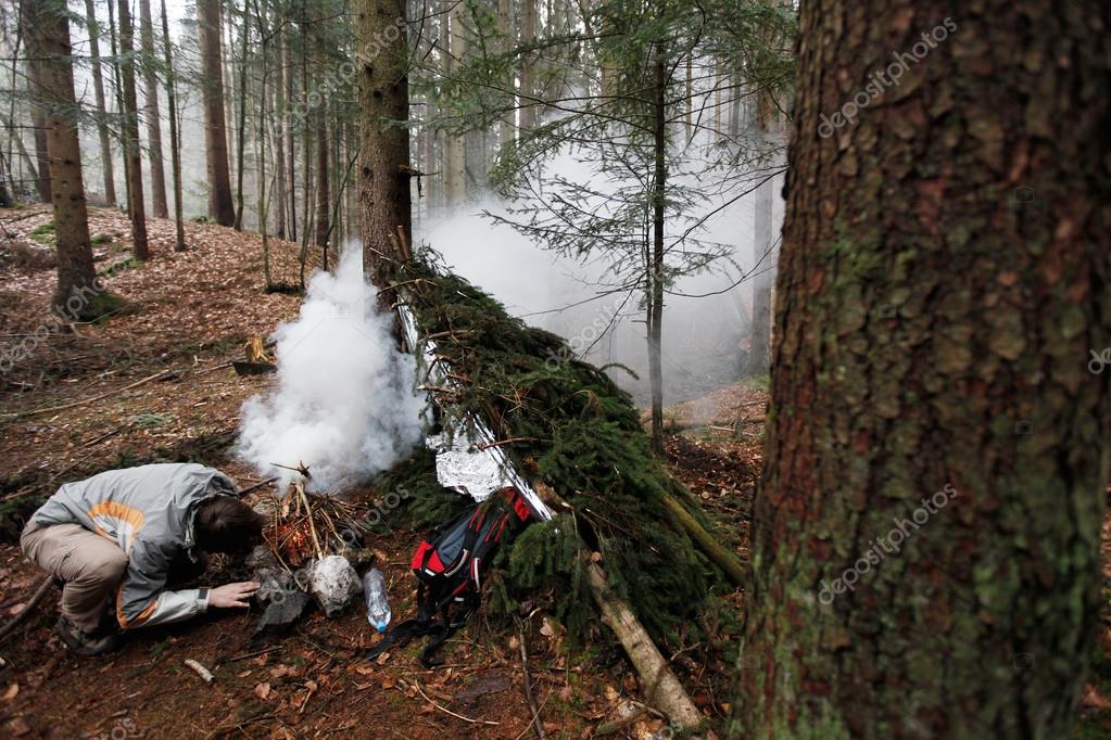 Man lighting an emergency fire — Stock Photo © zlikovec #78551260
