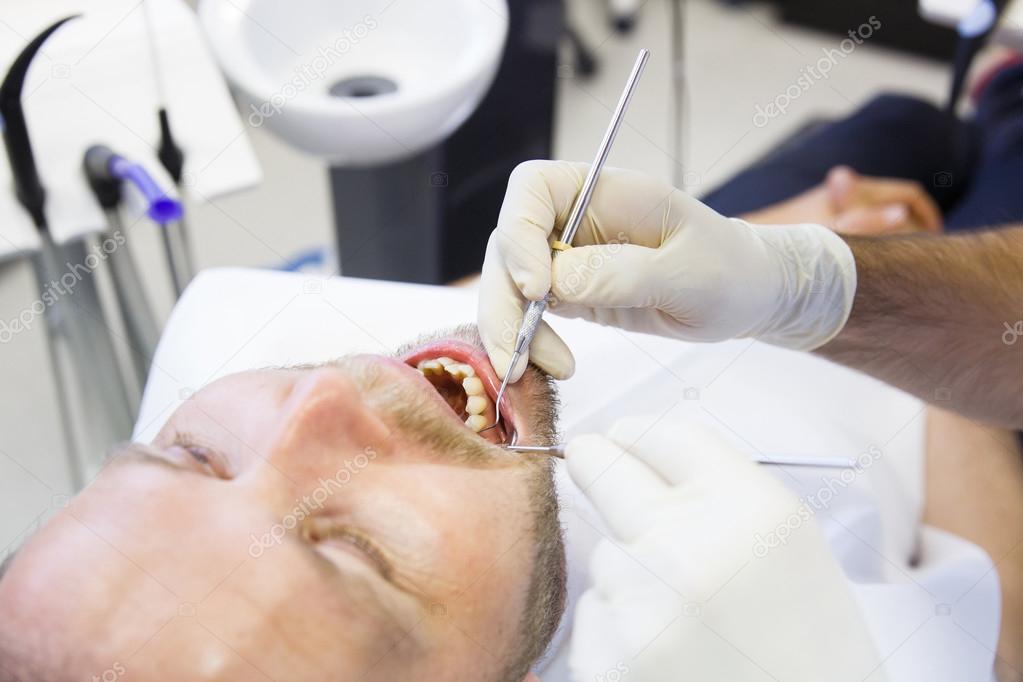 Patient in dental office on regular checkup — Stock Photo © zlikovec ...