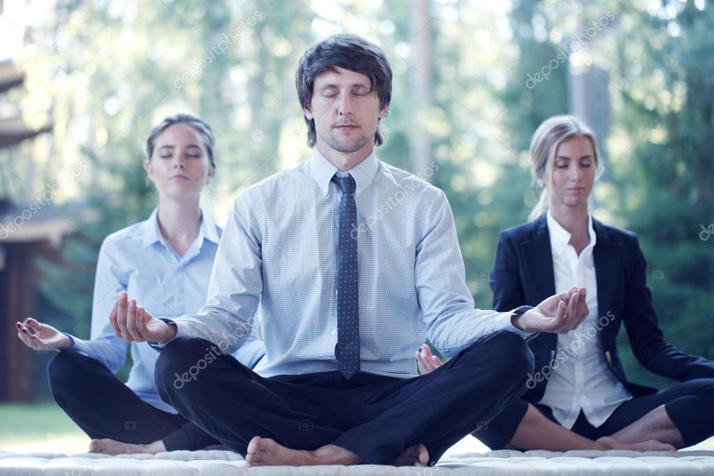 Business people practicing yoga Stock Photo by ©ALotOfPeople 100040096