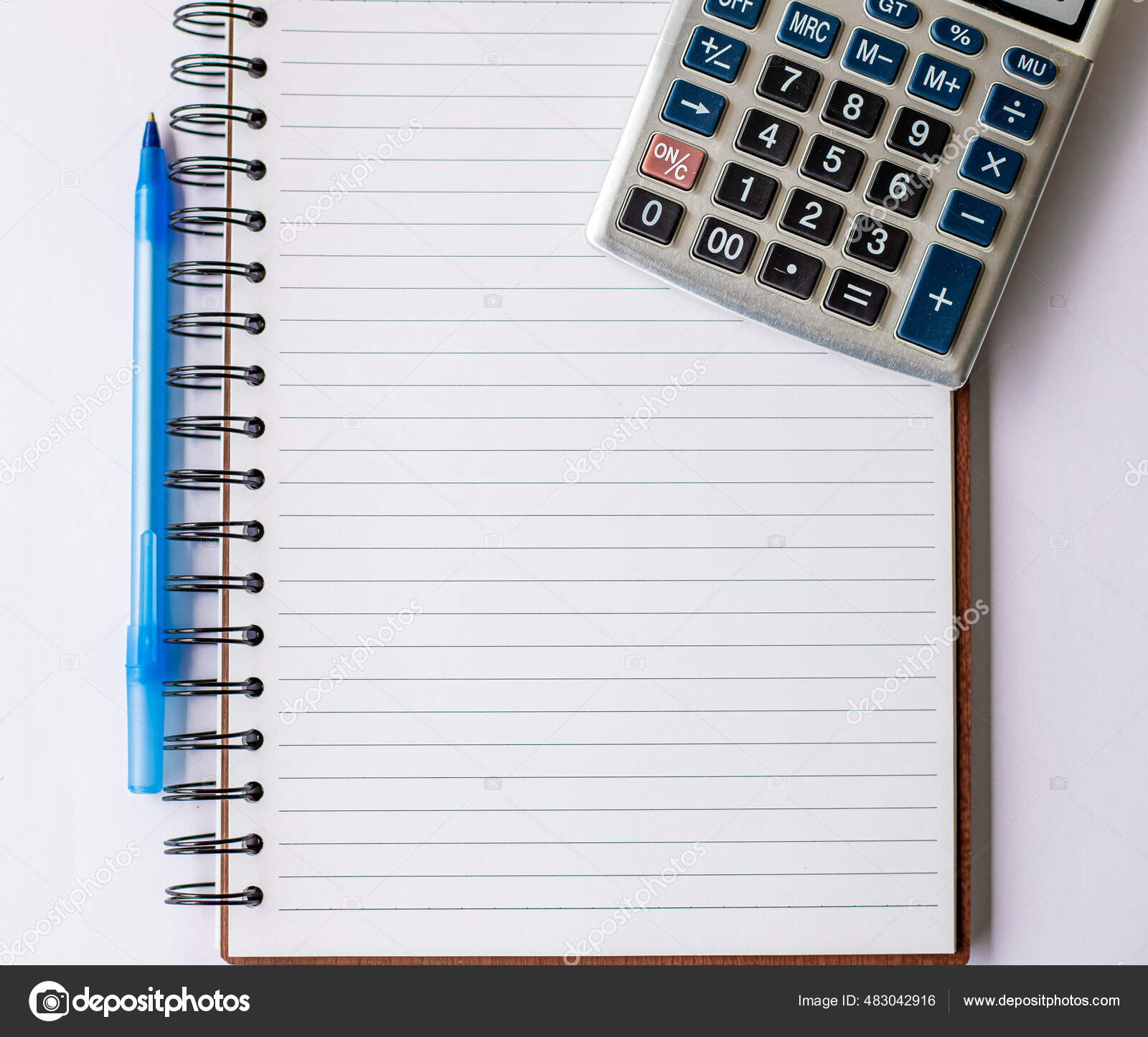 Blank Opened Spiral Notebook With Calculator And Pen Placed Over Table ...