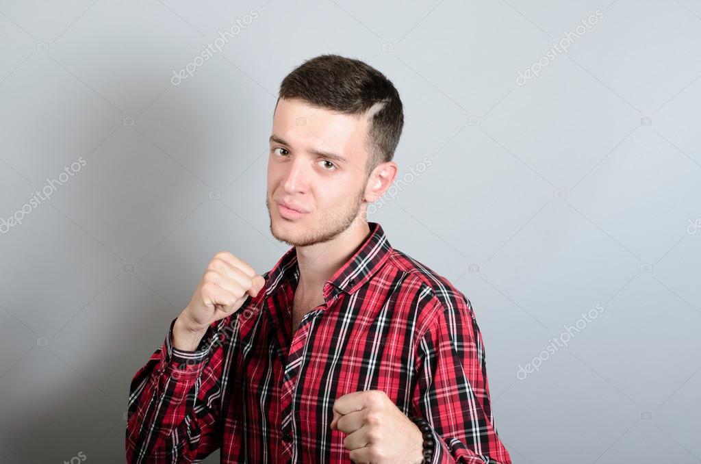 Boxing stand. The young man in standing position on a grey background ...