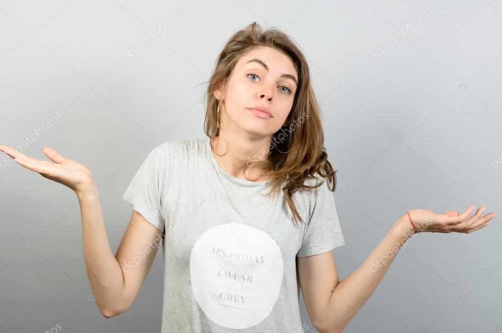 Beautiful attractive casual young woman with raised hands, Studio shot ...