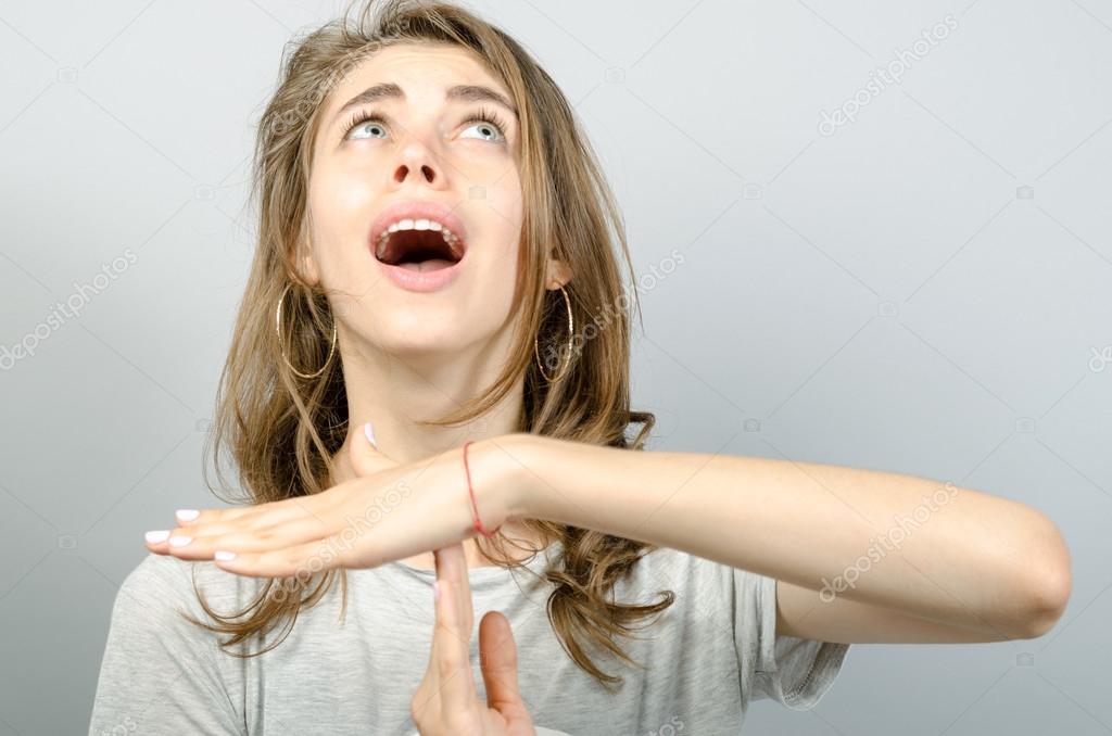 Young woman showing stop timeout. On a gray background. Stock Photo by ...