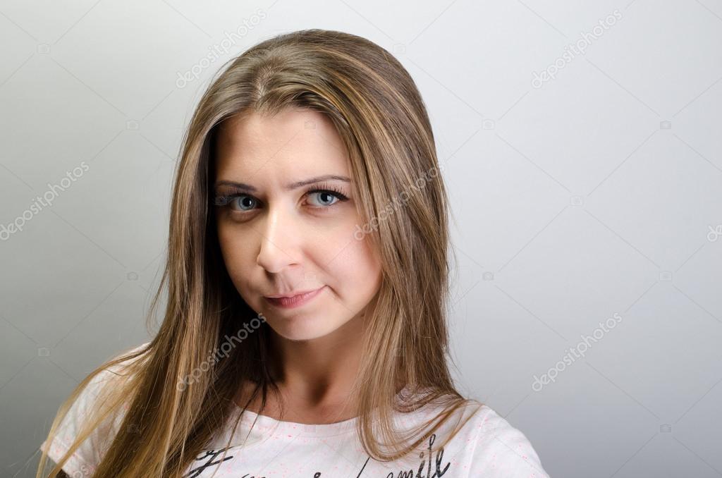 Girl looking with suspicious on grey background Stock Photo by ...