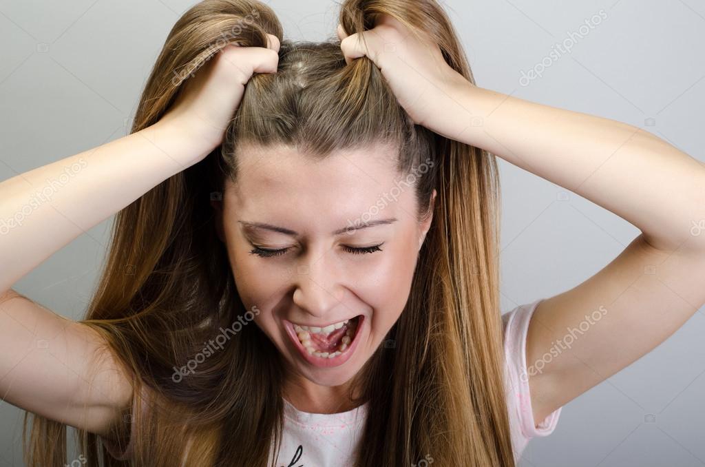 A very frustrated and angry woman pulling her hair Stock Photo by ...