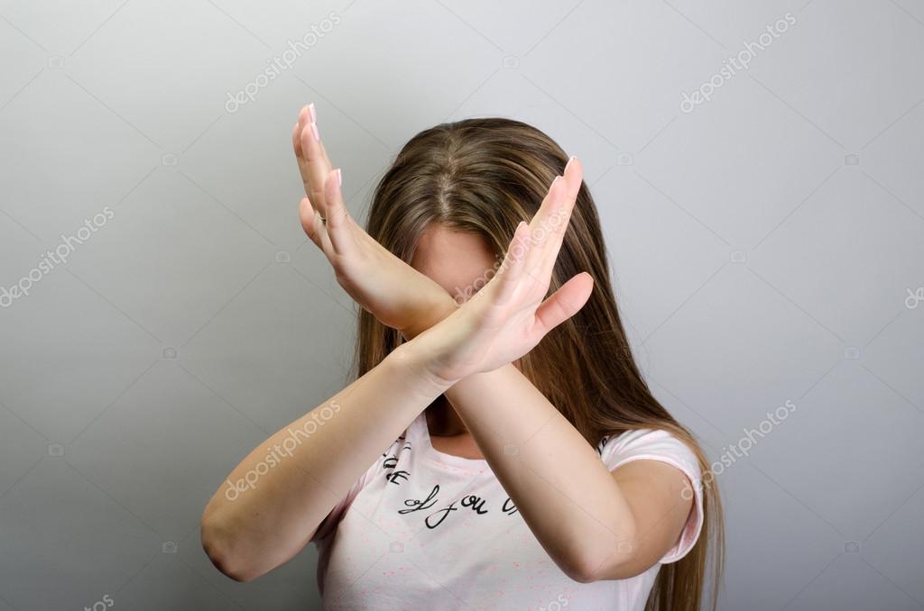 Woman showing a stop arms crossed. On a gray background. Stock Photo by ...
