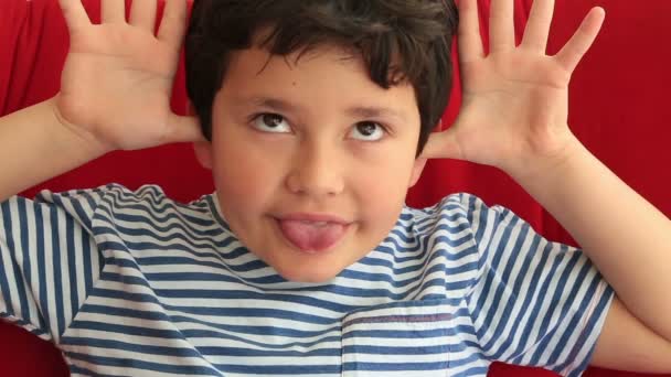 Child making funny silly faces 3 — Stock Video © DerinMedia #73809887