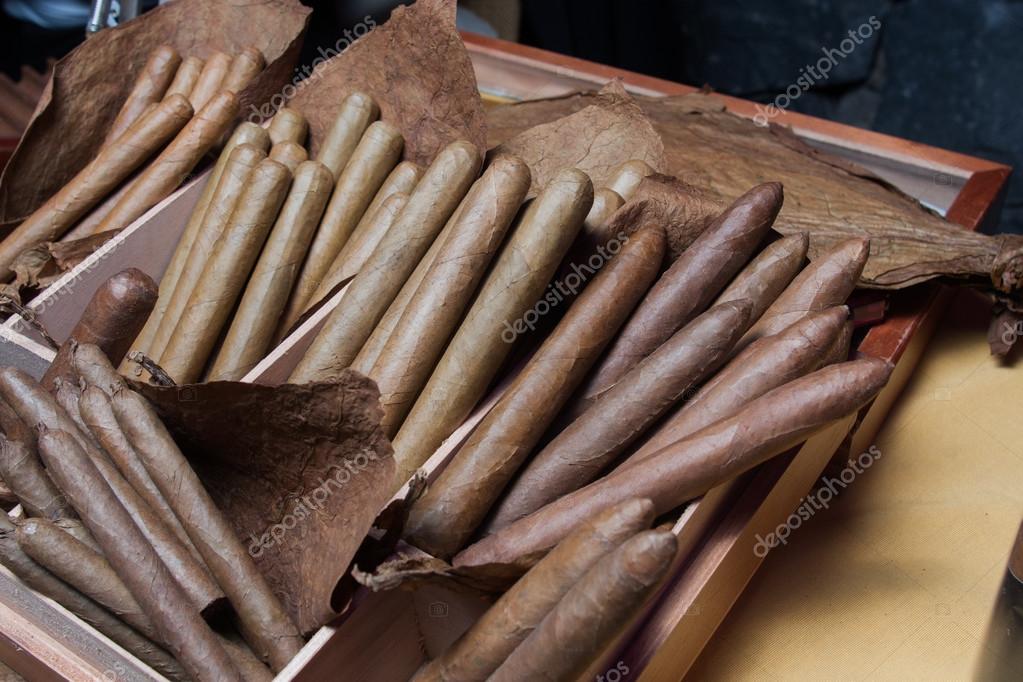 Hand made cigars parejos on wooden table — Stock Photo © johnqsbf #99059424