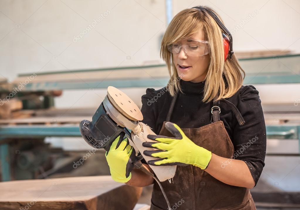 Female carpenter Using Electric Sander Stock Photo by ©guruxox 101222778
