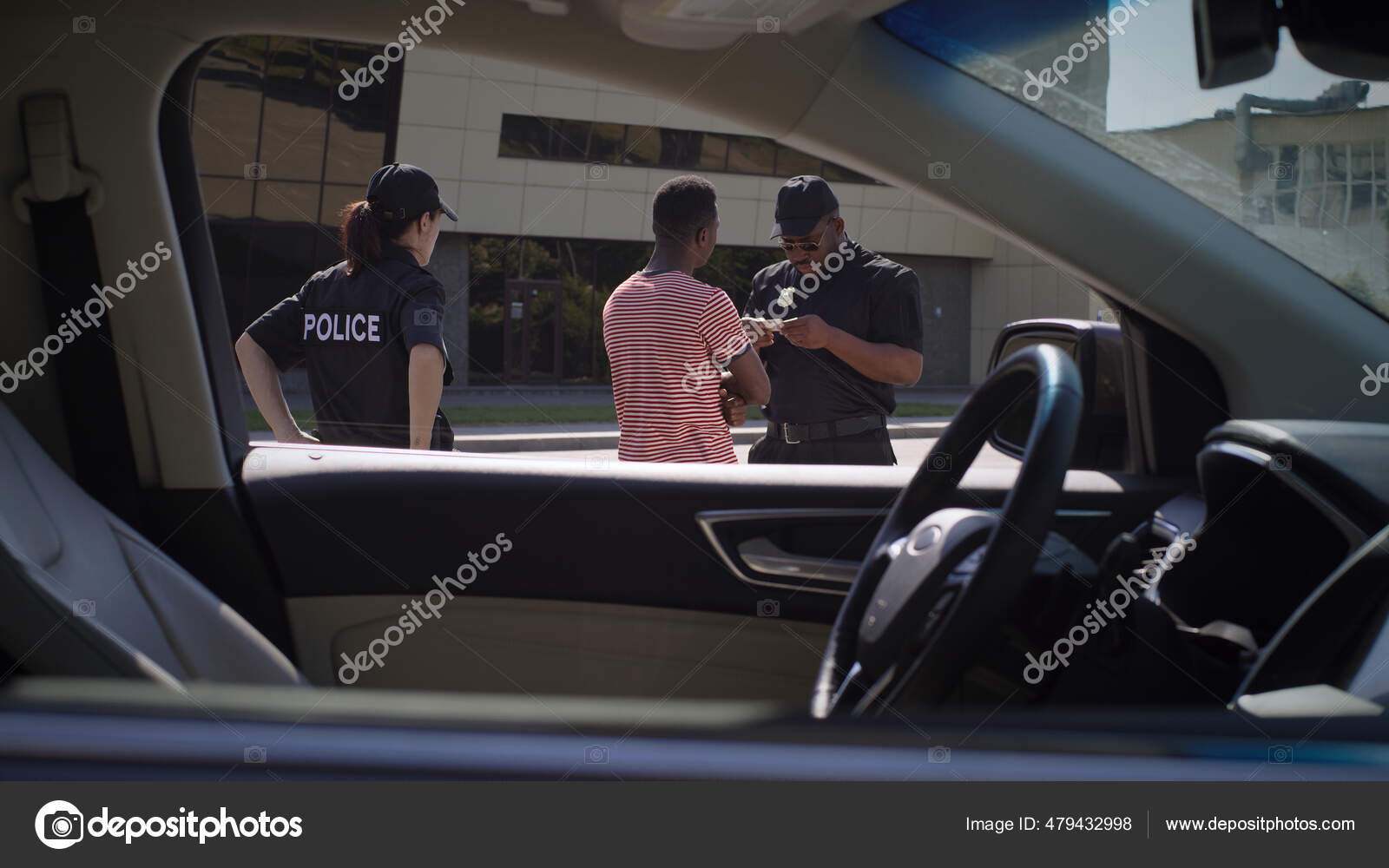 Diverse police officers checking documents of black driver — Stock ...