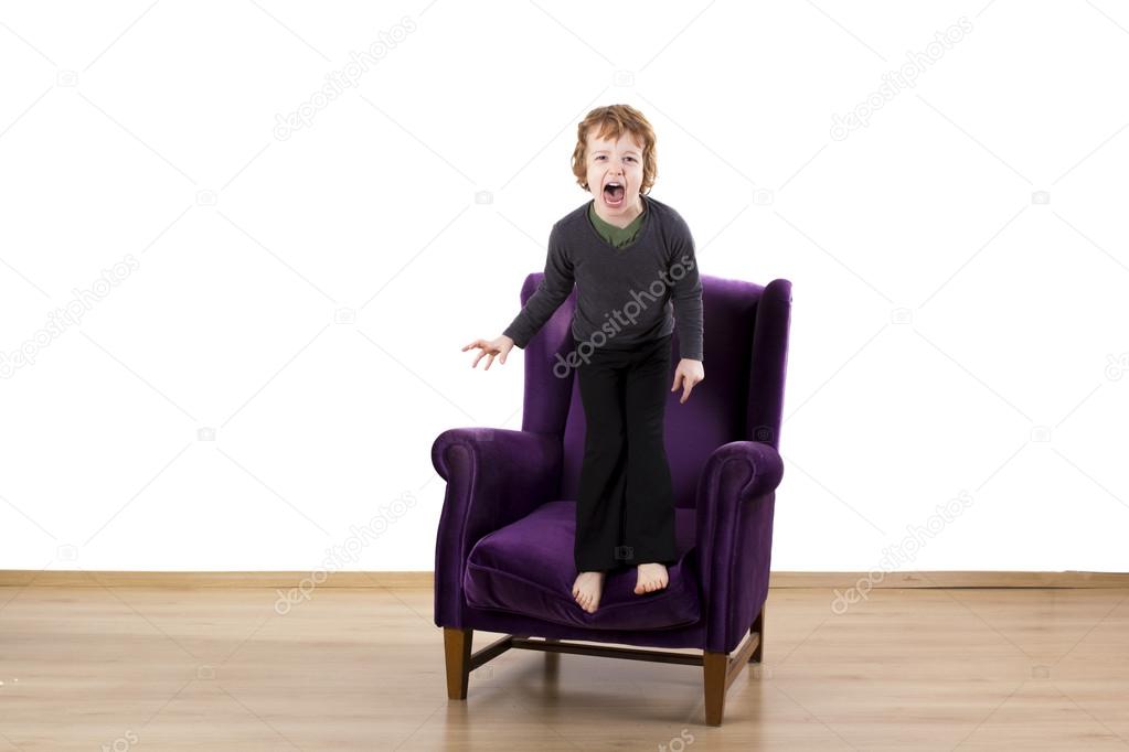 Child tantrums angry screaming on an armchair Stock Photo by ...