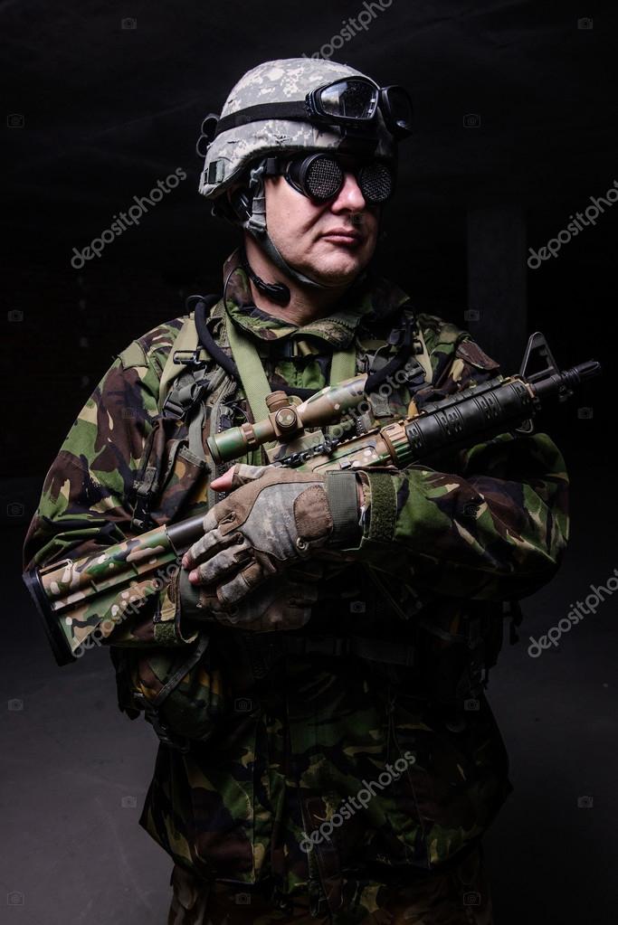 Man with gun in uniform Stock Photo by ©Nesterenko_Max 120592424
