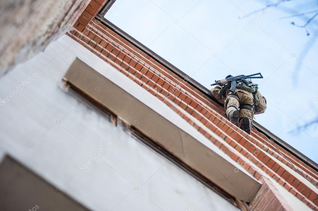 Armed soldiers on the edge of the roof Stock Photo by ©Nesterenko_Max ...