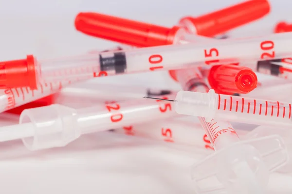 Pile of Empty Syringes with Red Safety Caps - Stock Image - Everypixel
