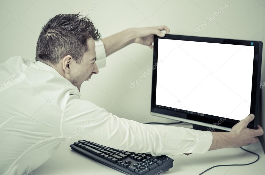 Angry man grabbing his computer with a white screen Stock Photo by ...