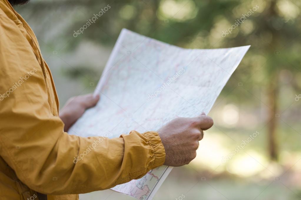 Man with a map in hands Stock Photo by ©Myvisuals 115079972