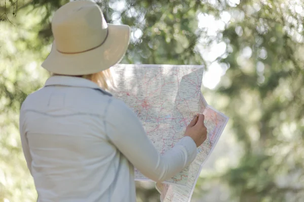 Female explorer looking at a map outdoor - Stock Image - Everypixel