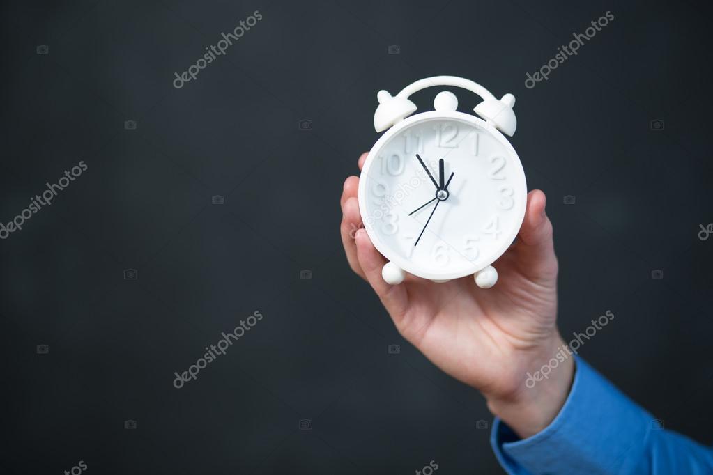 Time. man is looking at clock with chalk board behind him Stock Photo ...