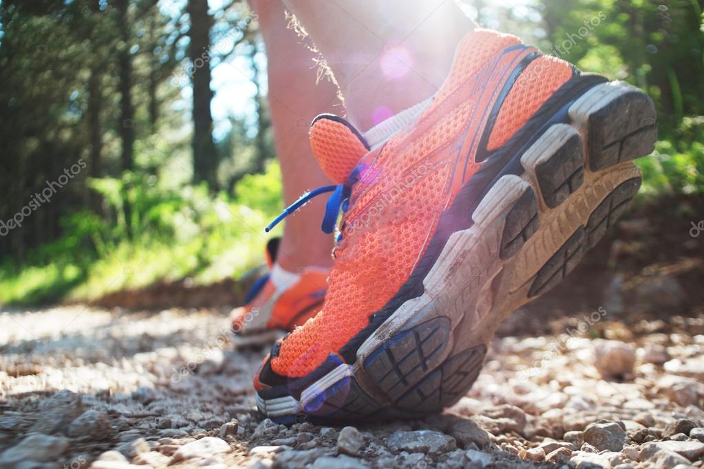 Close up of man walking on nature trail near forest preserve. Co ...
