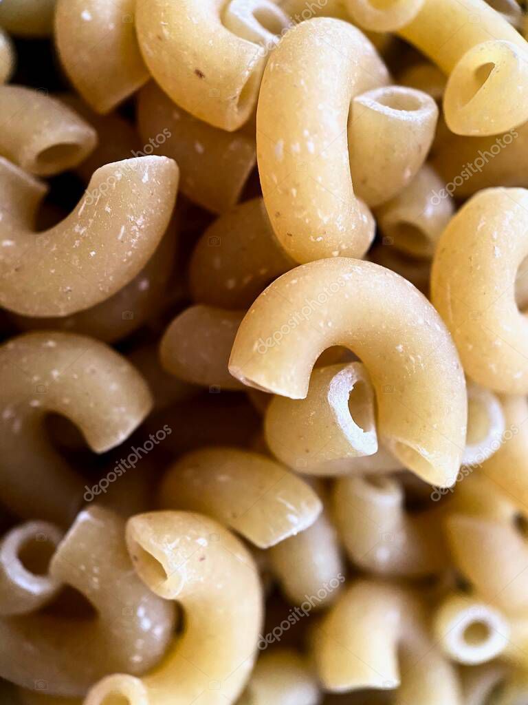 Closeup of dried elbow macaroni pasta. Dry pasta is made from finely ...