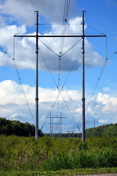 The high voltage line is in the field. Electric pole energized. Power ...
