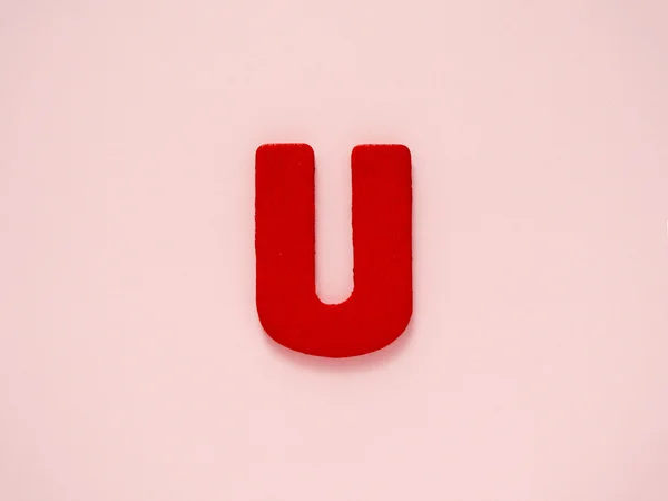 Capital letter U. Red letter U from wood on pink background. Alphabet ...