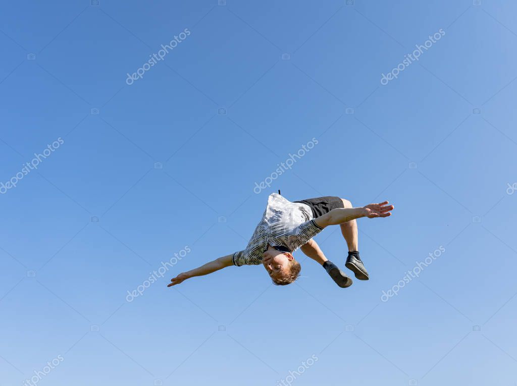 El tipo es un acróbata saltando y haciendo volteretas en el fondo de un ...