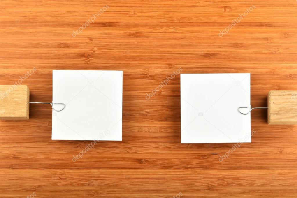 Two paper notes with holders in different directions on wood — Stock ...