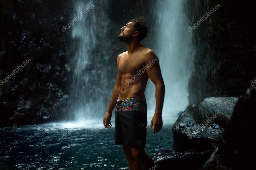 Handsome man at waterfall — Stock Photo © Diana.mironenko #93998408