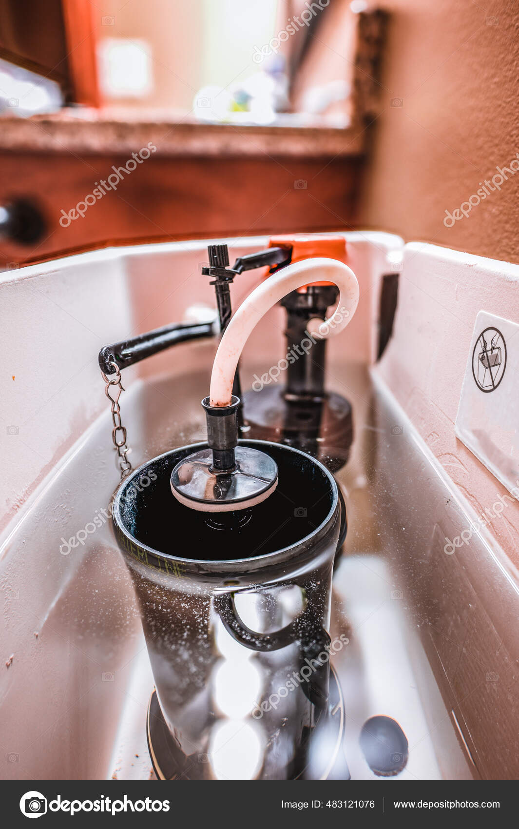 Dentro del tanque de agua del inodoro con flotador levantado ...