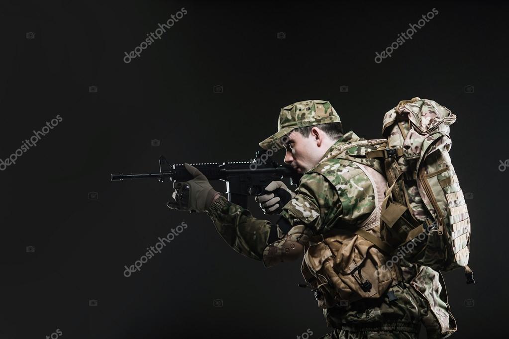 Soldier man hold Machine gun on a dark background Stock Photo by ...