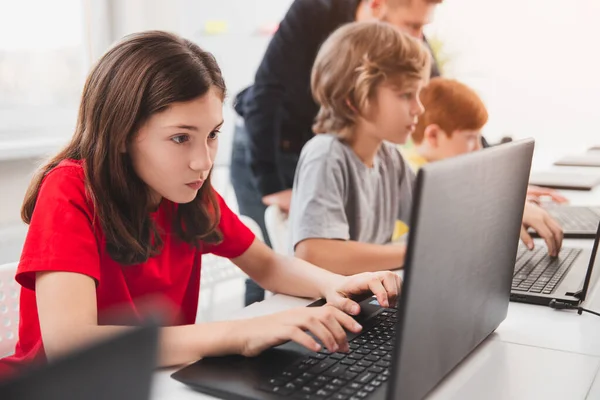 Pupils with teacher during computer science lesson - Stock Image ...