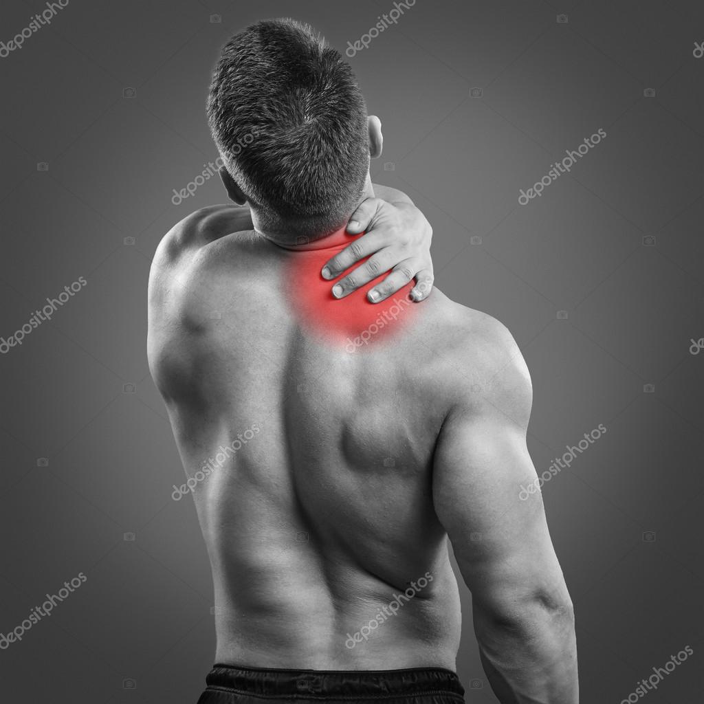 Back view portrait of a man with neck pain over gray background ...