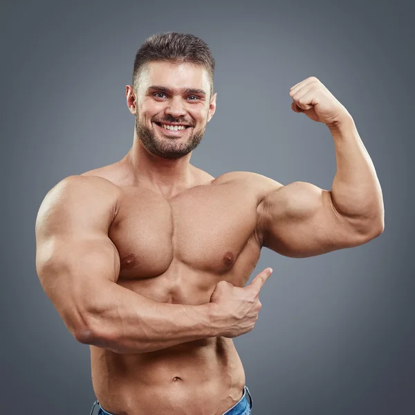 Smiling handsome man with muscular torso Stock Photo by ©kegfire 96666718