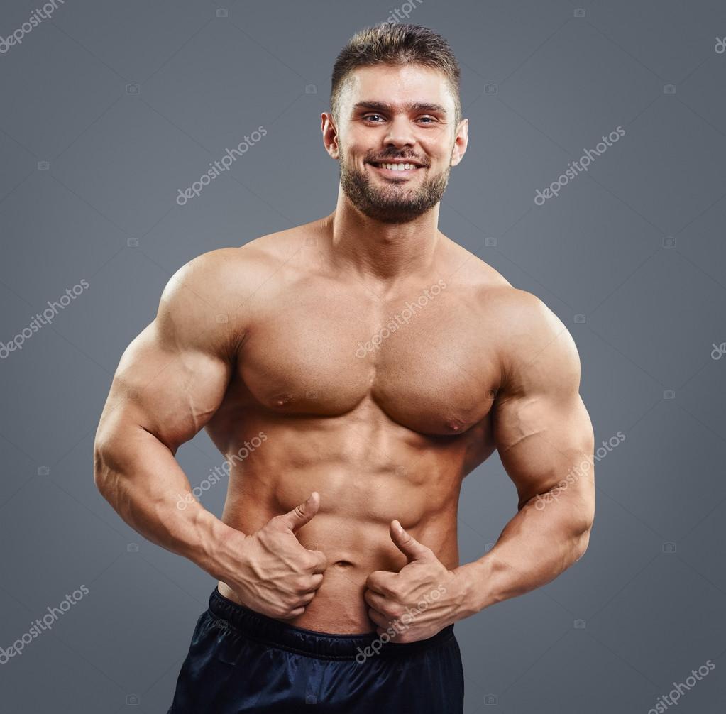 Smiling handsome man with muscular torso Stock Photo by ©kegfire 96666718